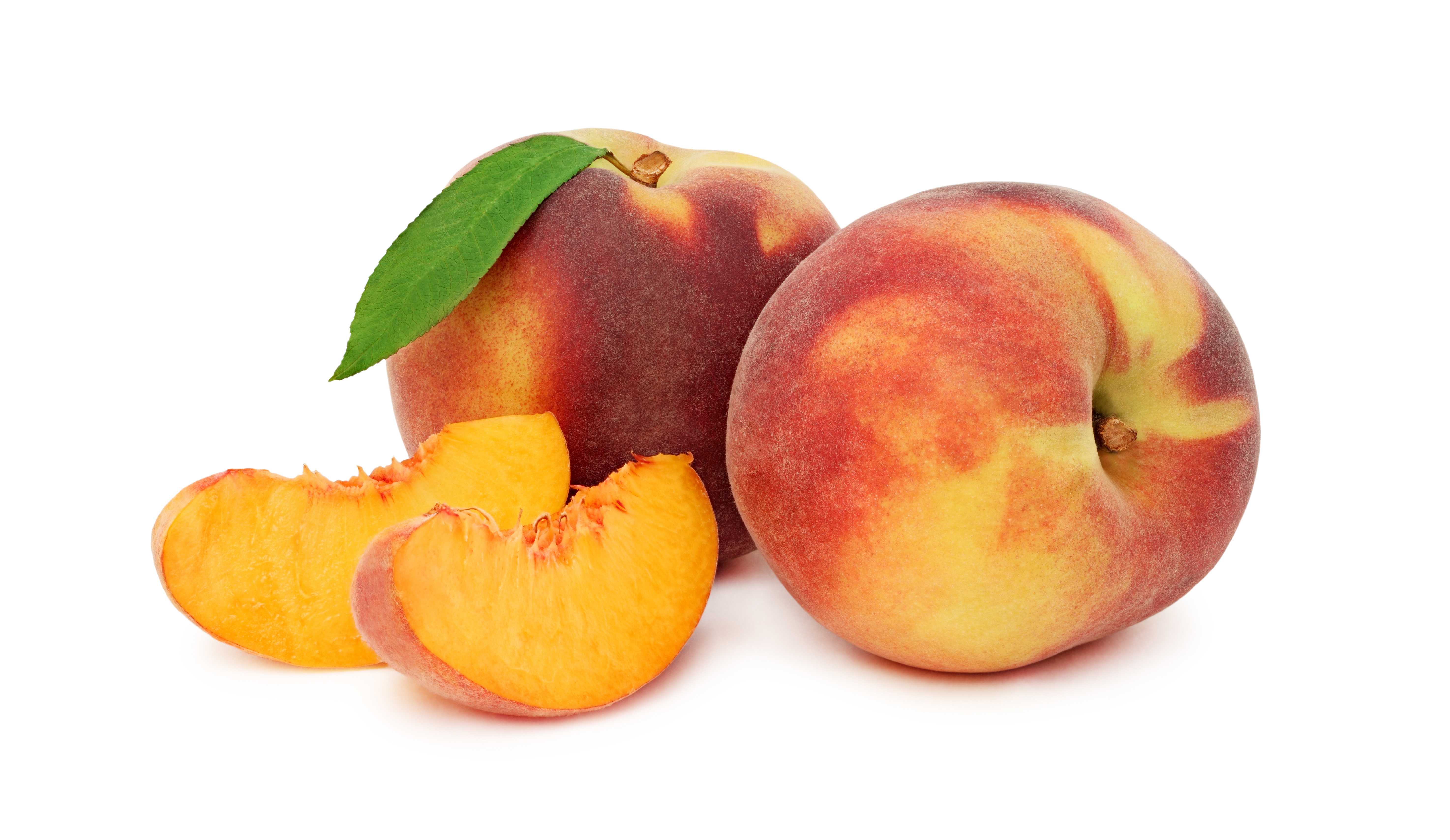 Two whole peaches with green leaf and slices (isolated)